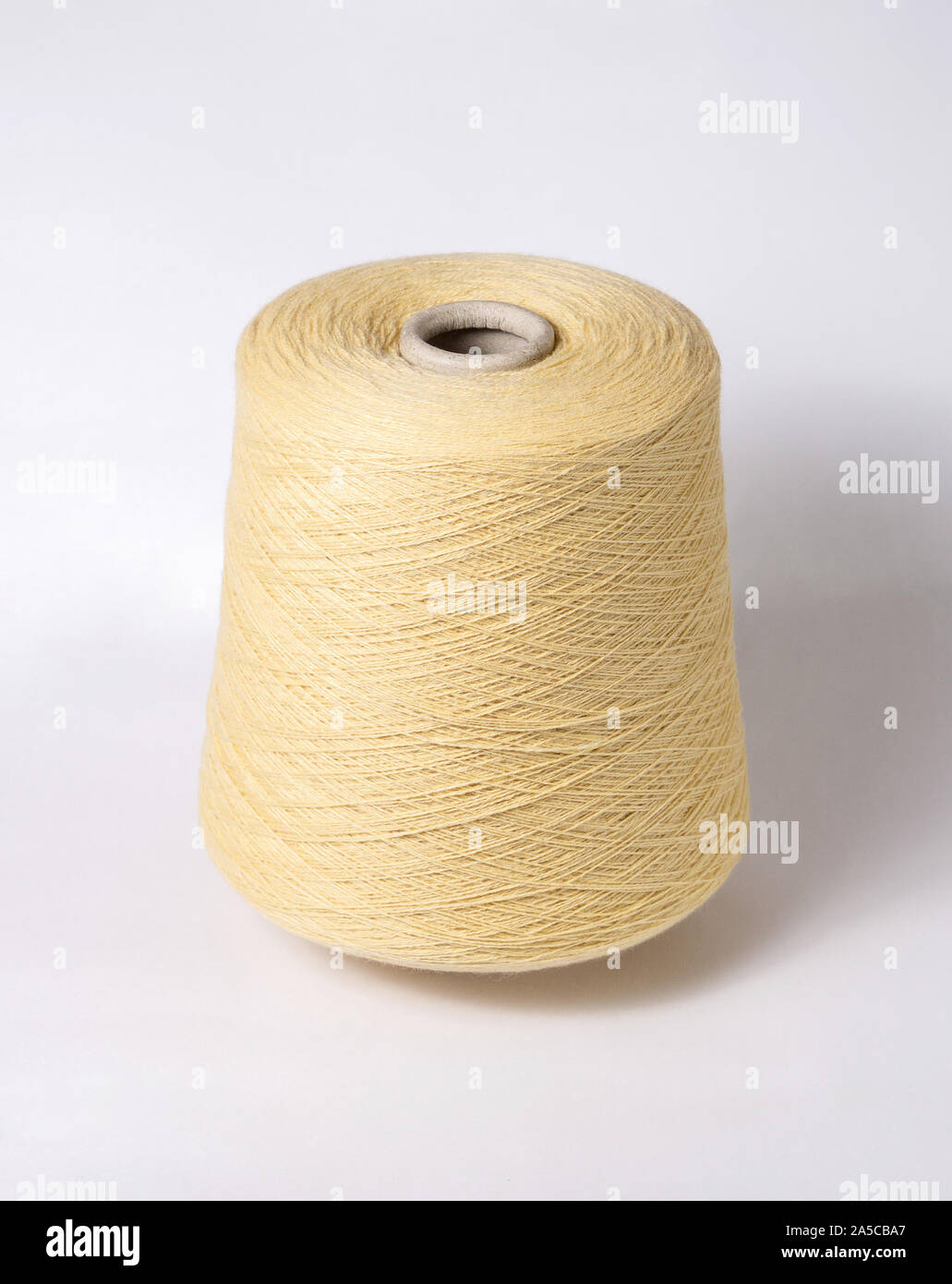 bobbin of yarn on a white background. Side view.Textile reel on ...