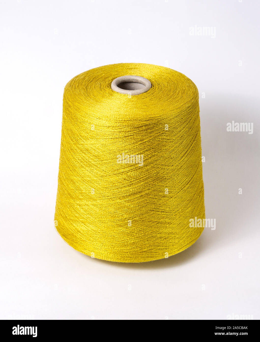 bobbin of yarn on a white background. Side view.Textile reel on ...
