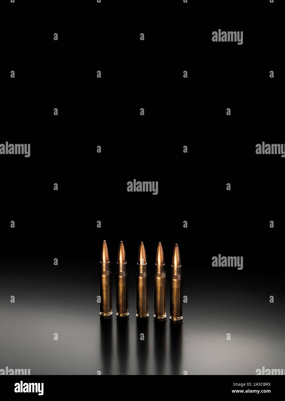 Bullet isolated on black background with reflexion. Rifle bullets close ...