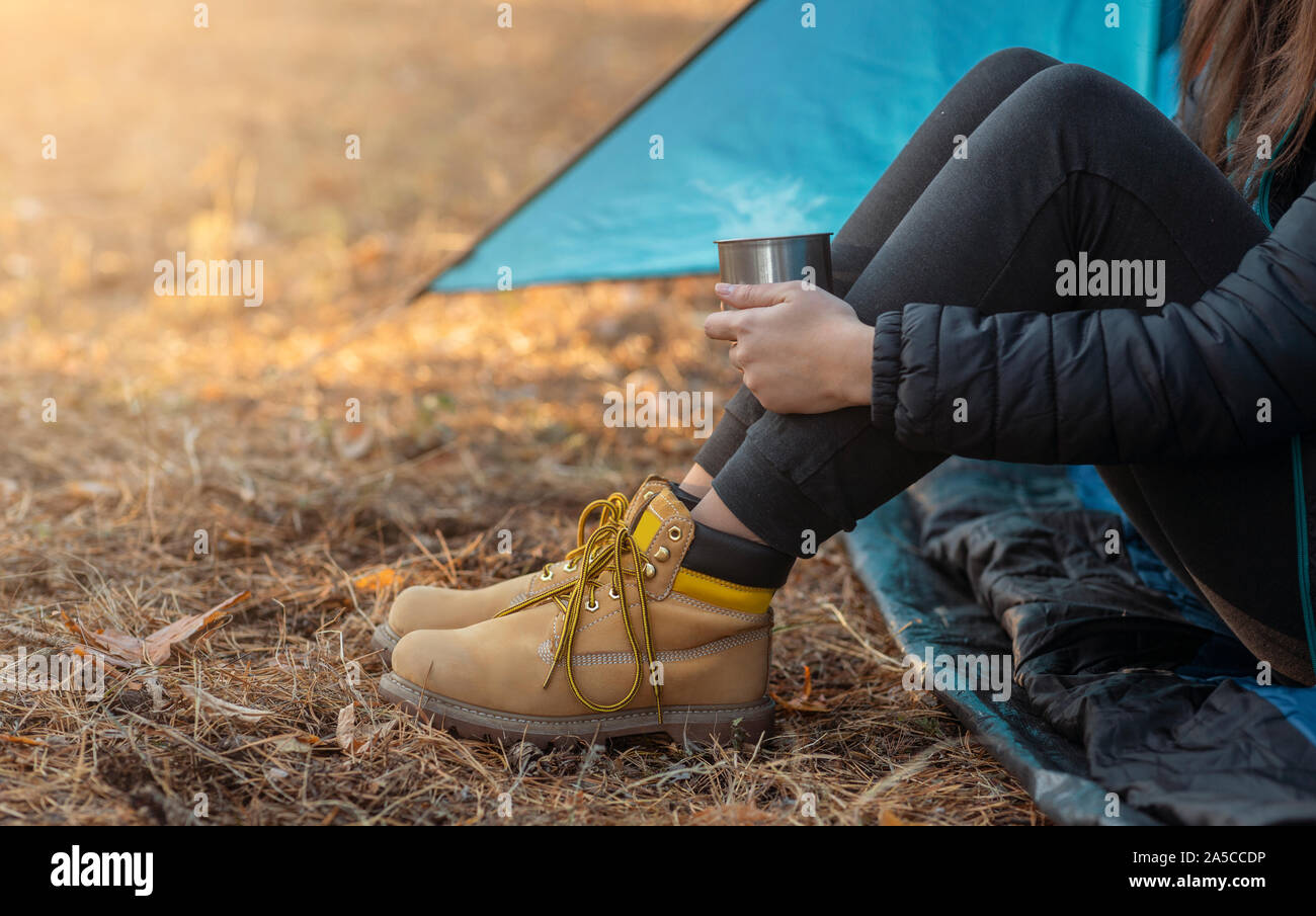 Legs in boots of woman camping in forest Stock Photo - Alamy