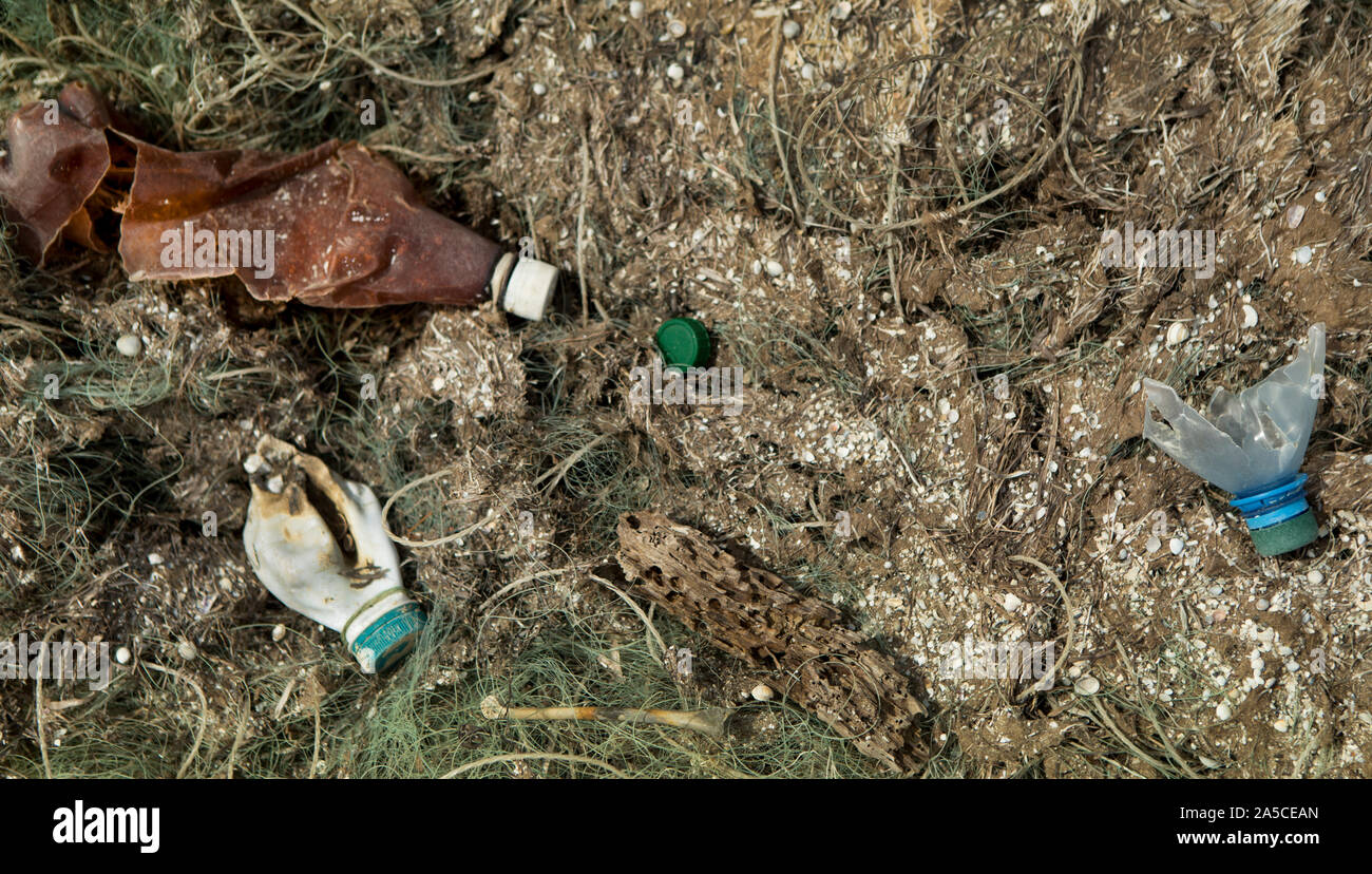 Rope fishing net with plastic garbage thrown out on sea beach Stock ...