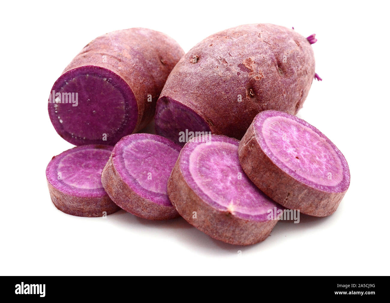 Purple Colored Sweet Potatoes on White background Stock Photo - Alamy