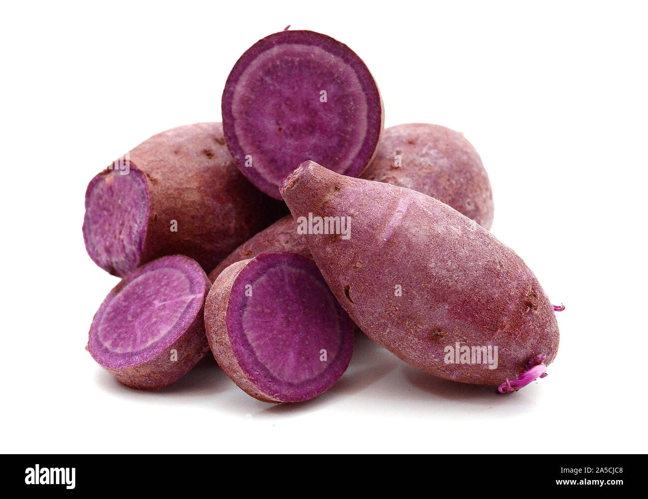 purple sweet potatoes on white background Stock Photo - Alamy