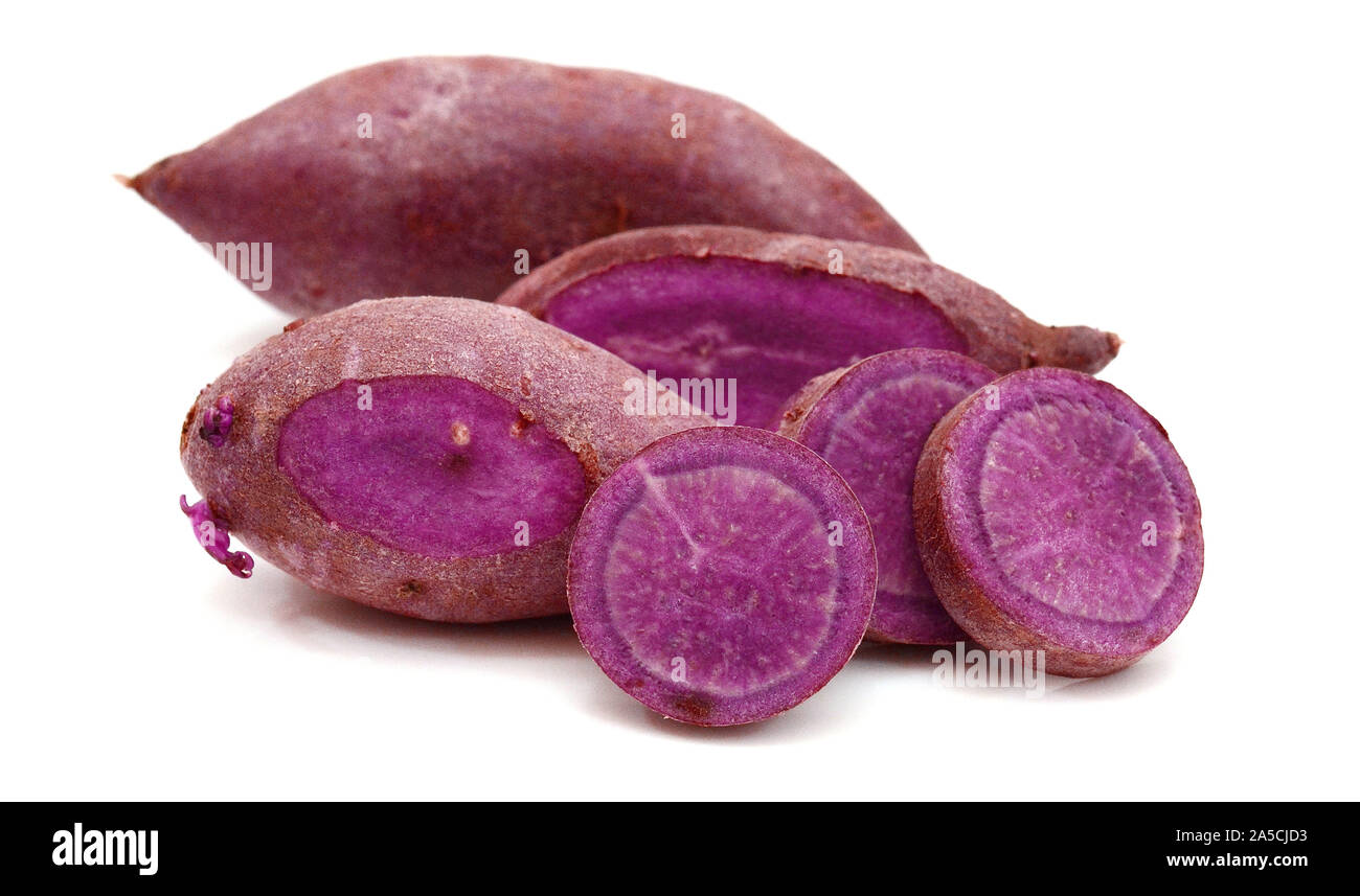 purple sweet potatoes on white background Stock Photo - Alamy