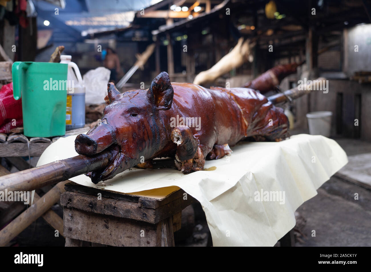 Spit roasted pig being prepared for delivery to a street vendor in ...
