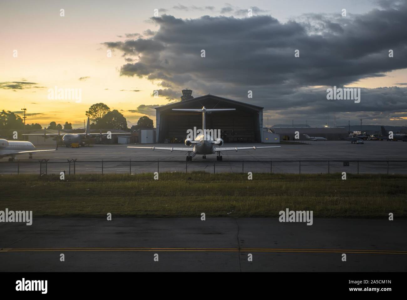 Horizontal shot of an airplane ready to take off during sunset under ...