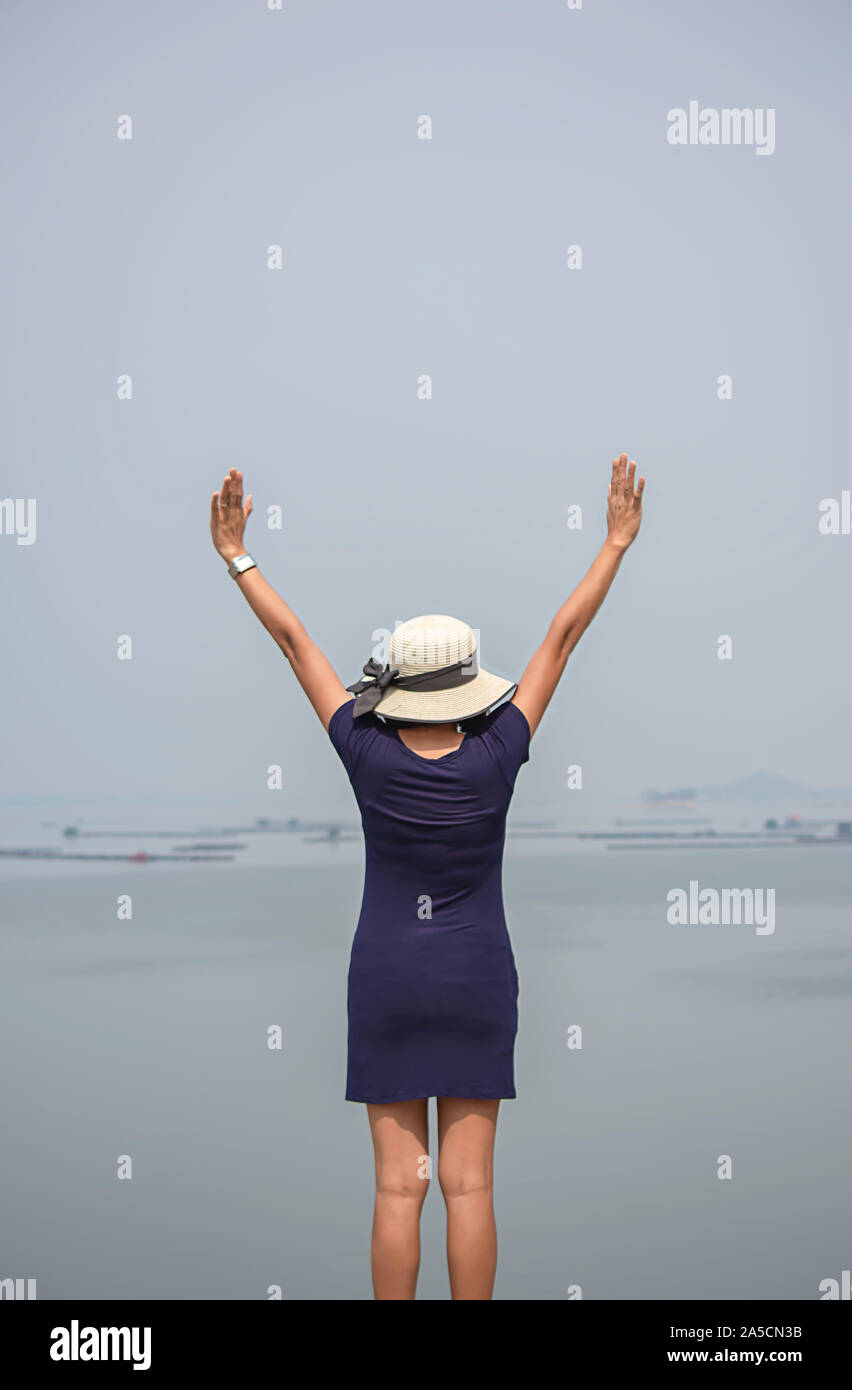 Women raise their arms Background The raft floating fish farming at ...