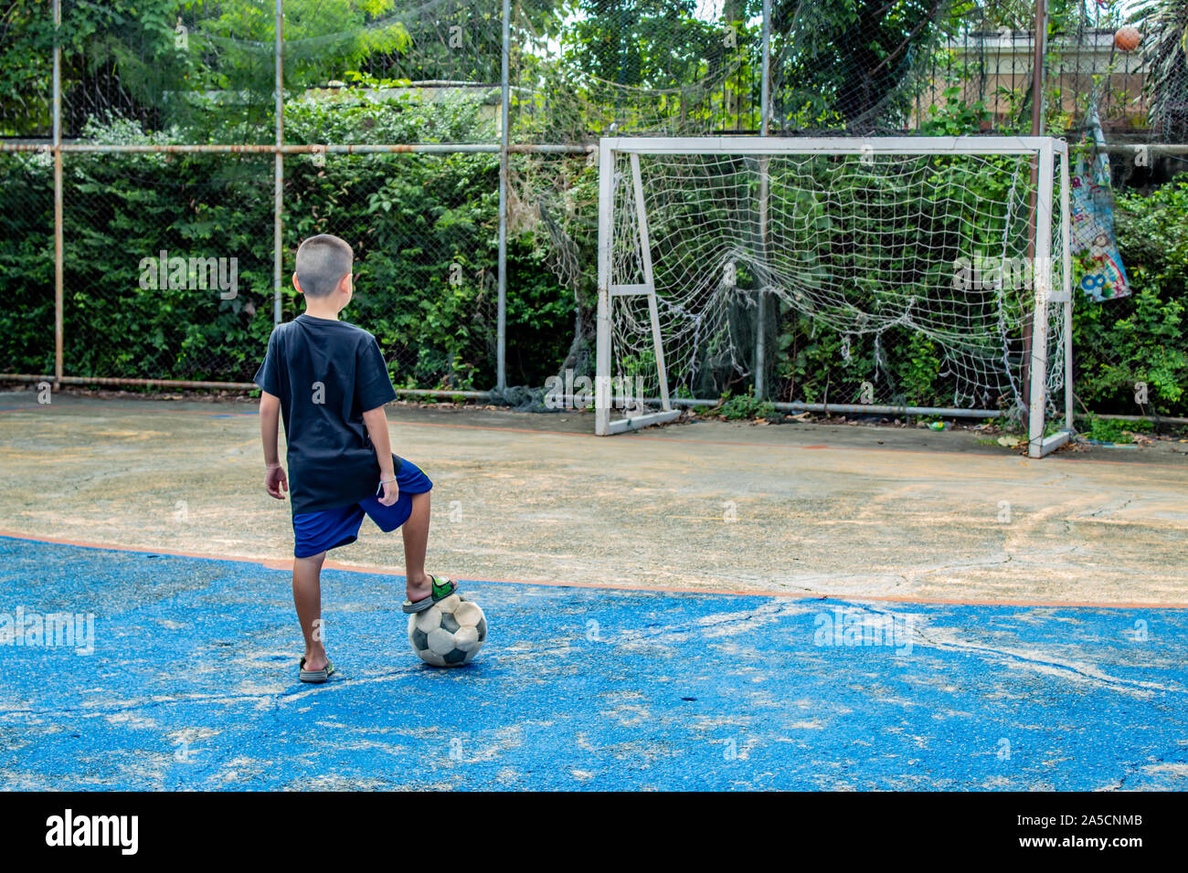 Boys playing football on playground hi-res stock photography and images ...