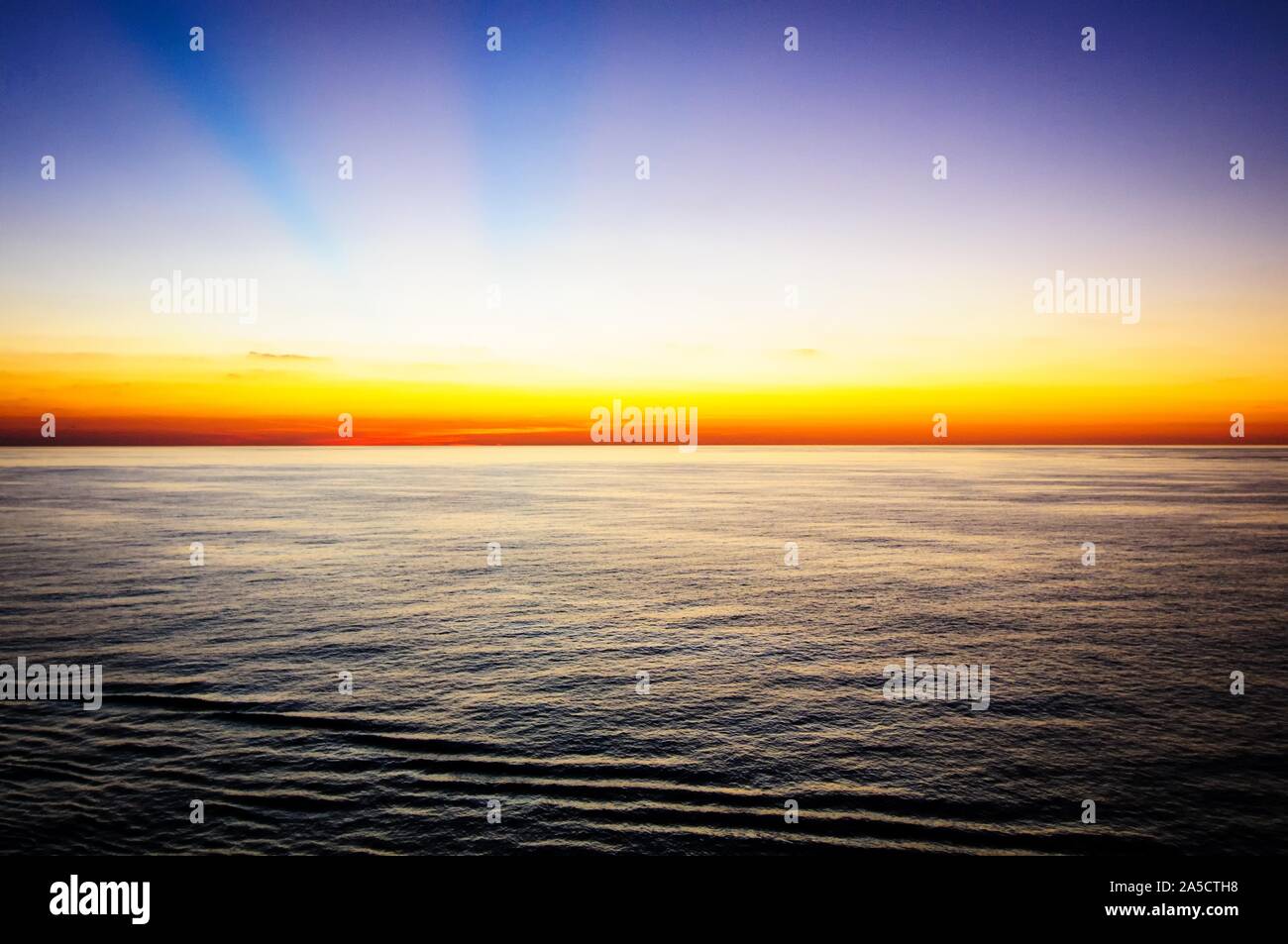 Beautiful sunset over the ocean looking like the sky has multiple ...