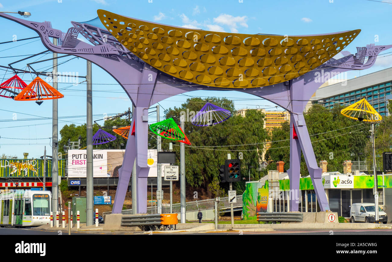 Gateway and streetlights of colourful metal conical hats homage to ...