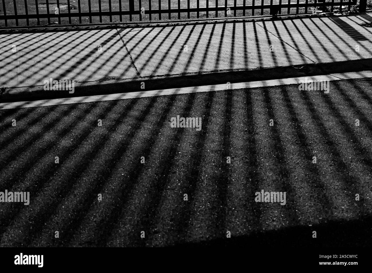 Greyscale shot of a ground with reflections of lines creating a ...