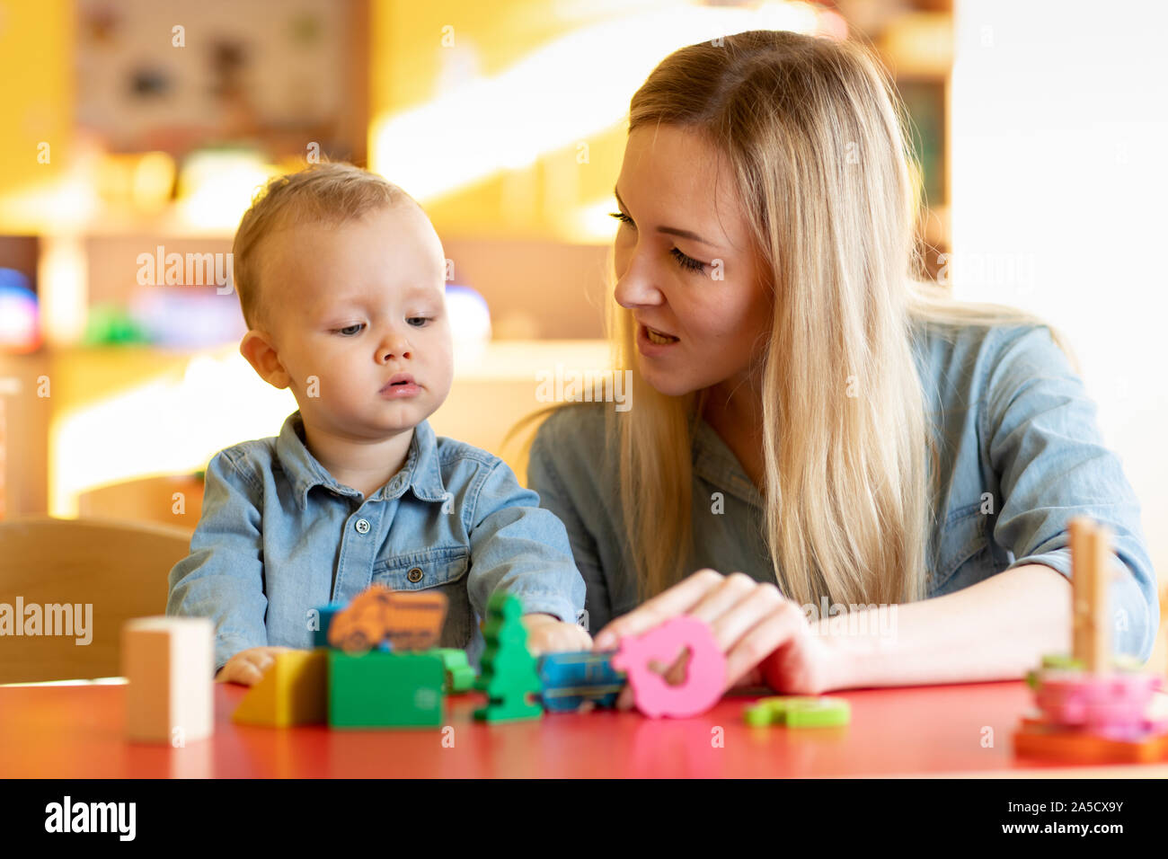 Mother and child son are talking and smiling while playing with ...
