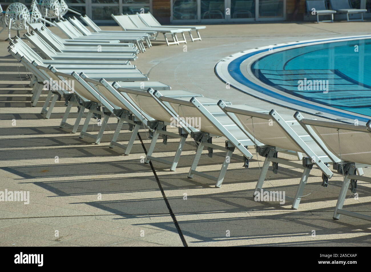 Outdoor swimming pool with chairs in hotel resort Stock Photo - Alamy