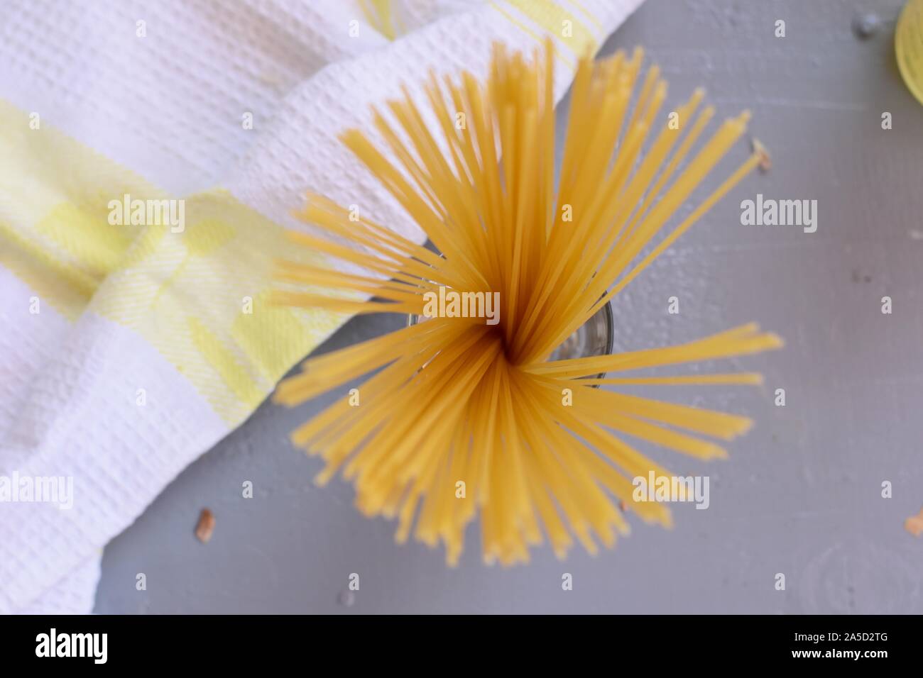 Yellow long spaghetti on a rustic background. Yellow Italian pasta ...
