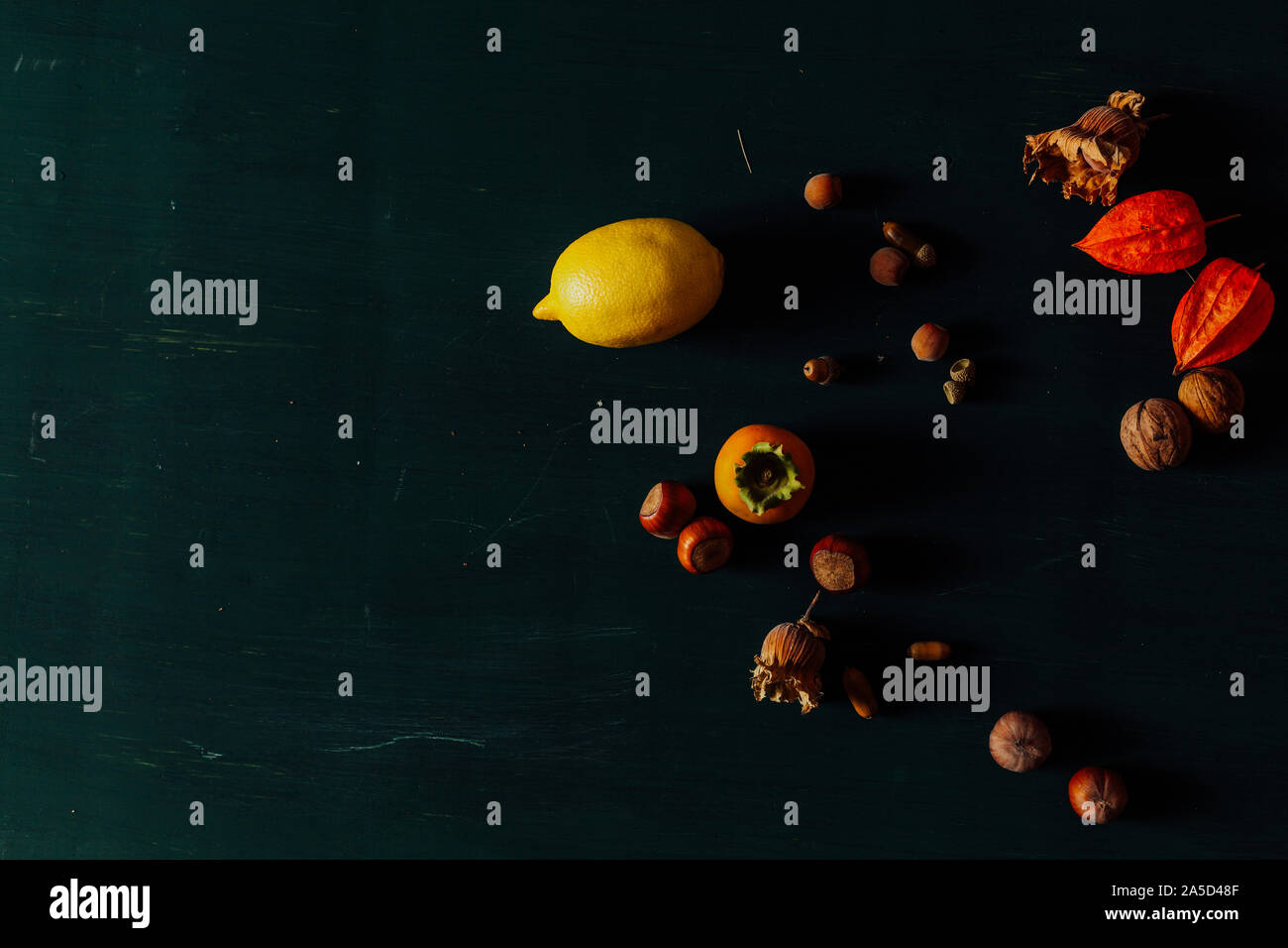 autumn nuts citrus on a green background Stock Photo - Alamy