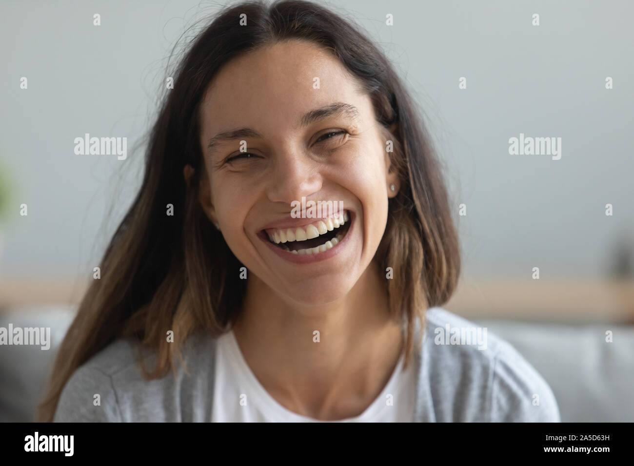 Happy positive attractive young woman laughing head shot close up Stock ...