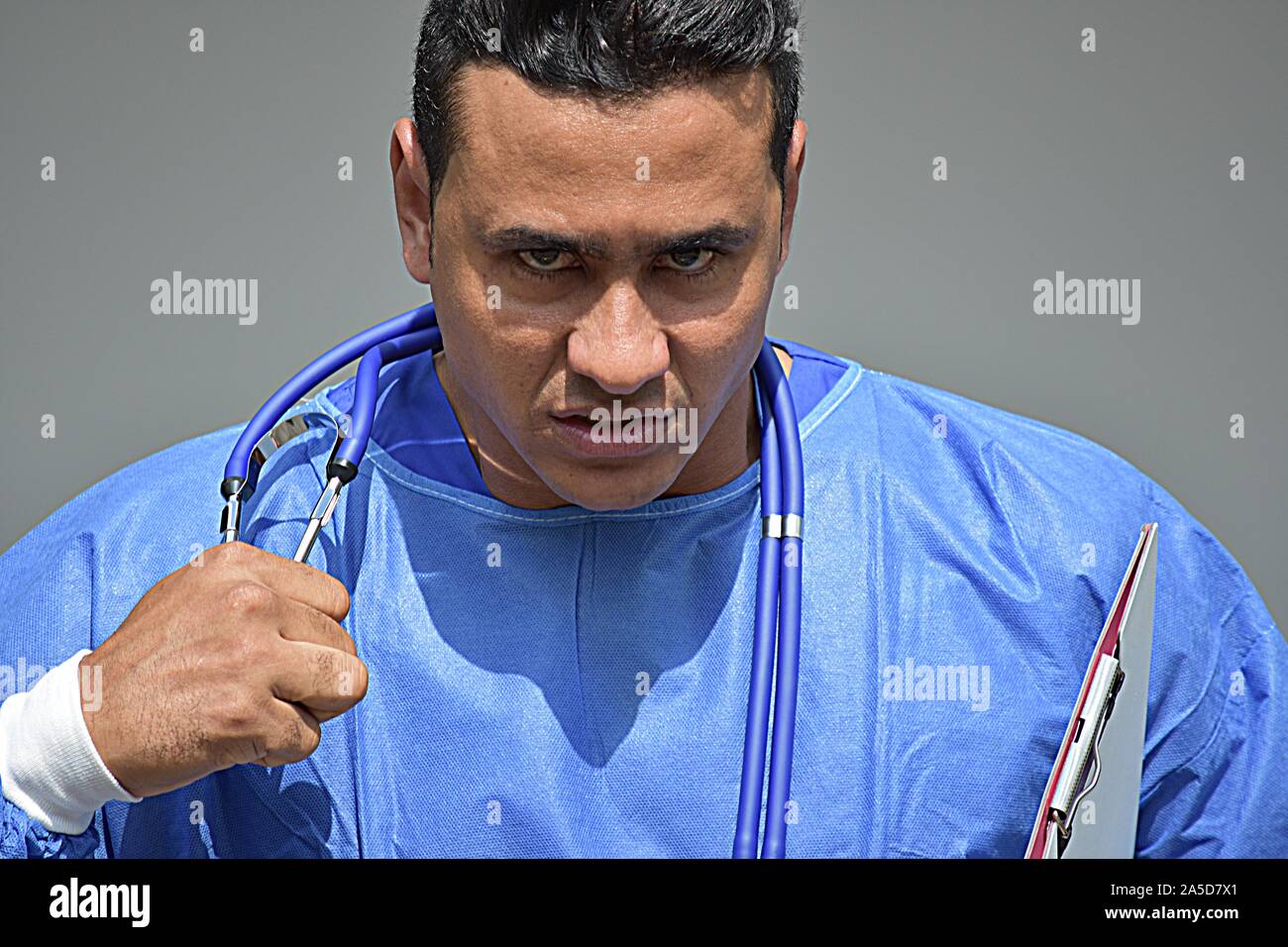 Male Surgeon Under Stress Wearing Scrubs With Clipboard Stock Photo - Alamy