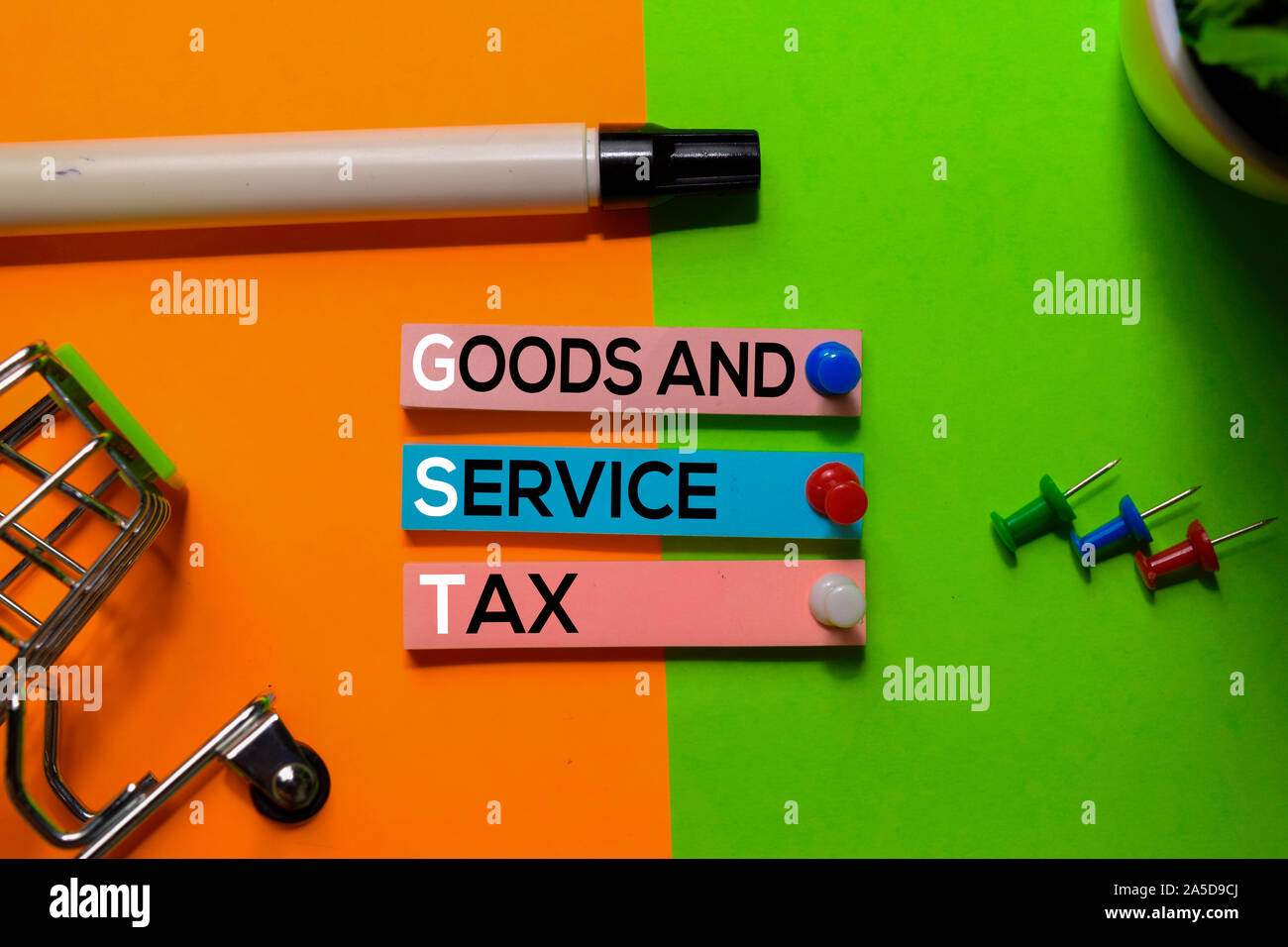 GST. Goods and Service Tax acronym on sticky notes. Office desk ...