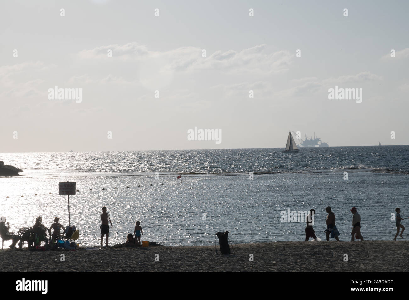 DOR BEACH, ISRAEL / 18 OCT 2019: Beachgoers relaxing on beach as ...