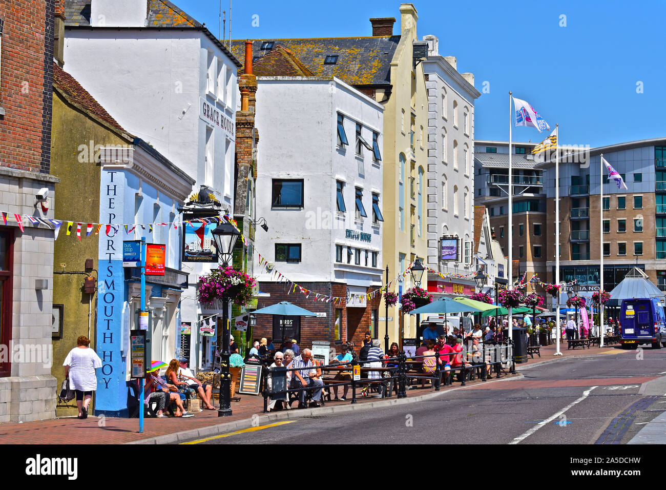 People sitting outside the colourful pubs & cafés,enjoying the sunshine ...