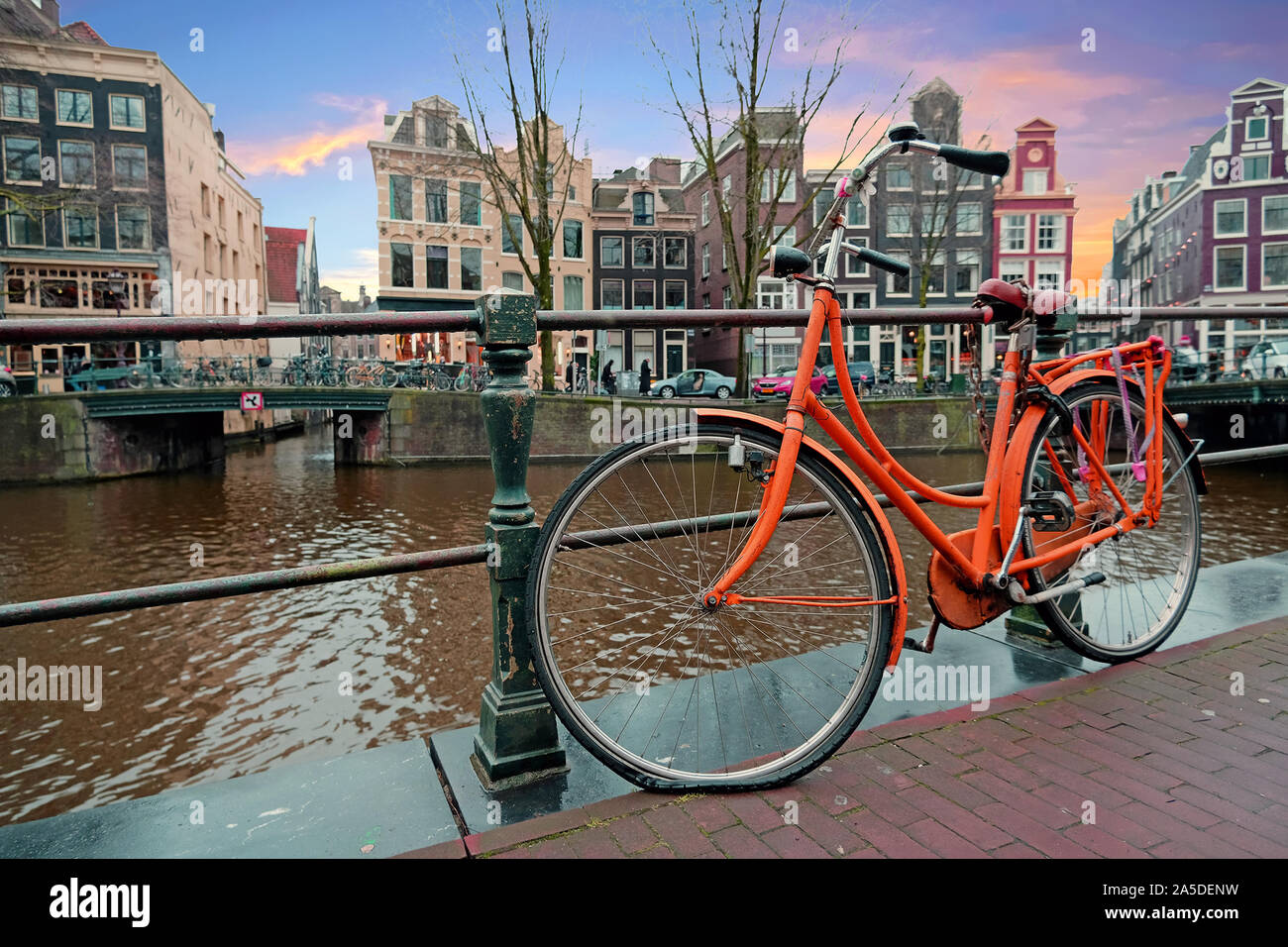 Orange bike along the canals in Amsterdam the Netherlands Stock Photo ...