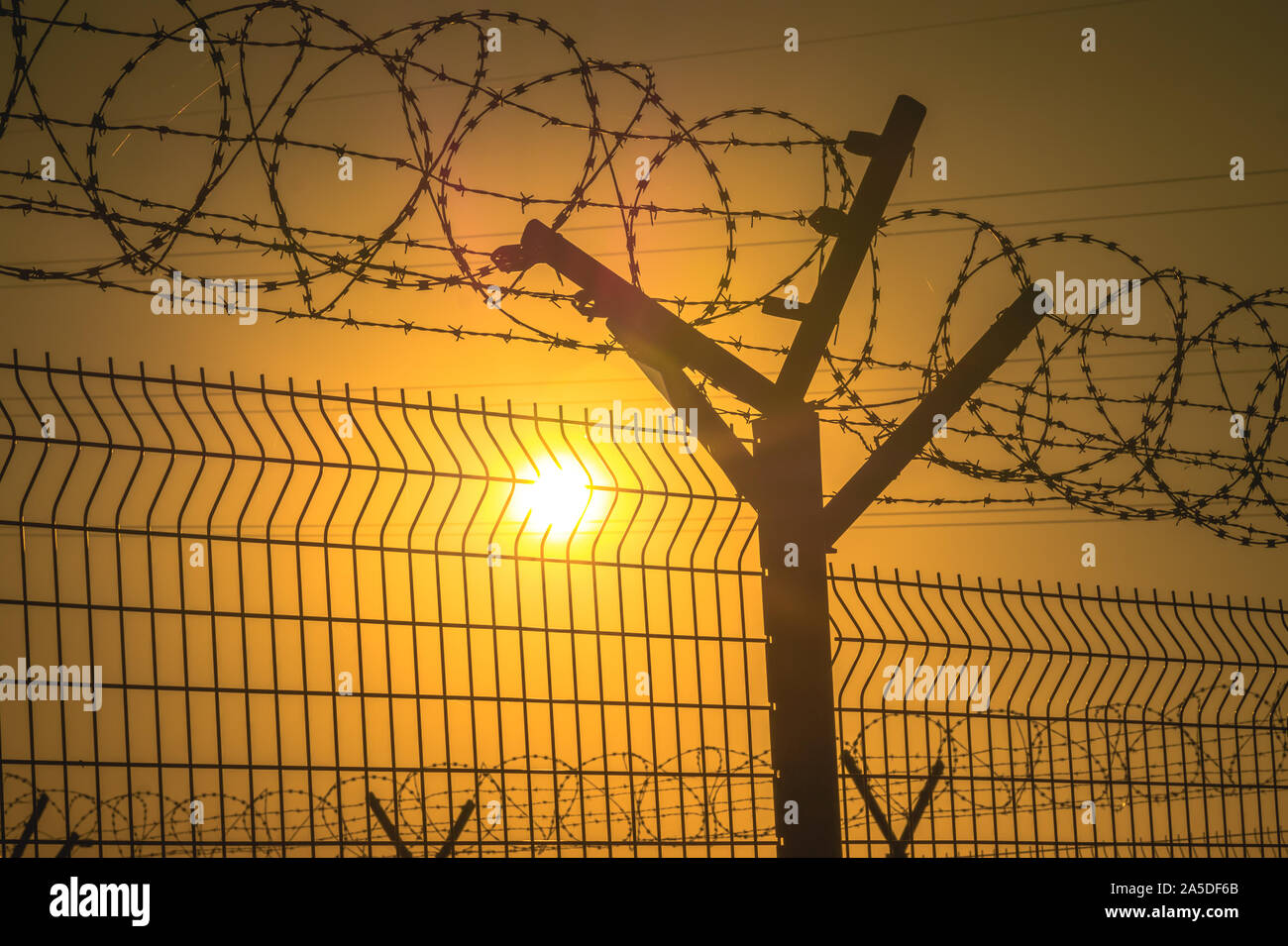 Barbed wire steel fence against the immigration in europe. Restricted ...