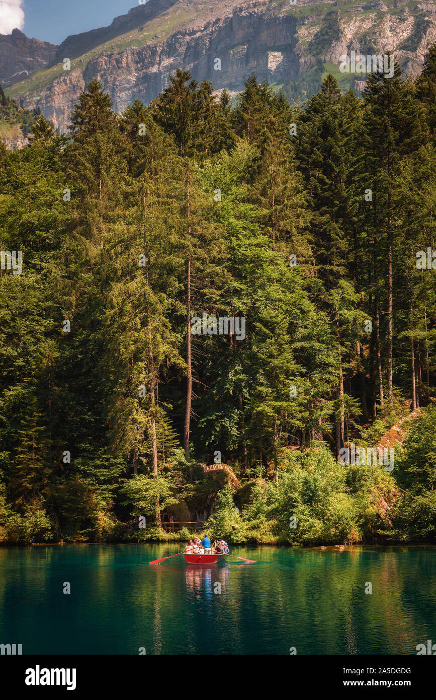 Tourists taking a boat trip on Blausee Lake in Switzerland Stock Photo ...