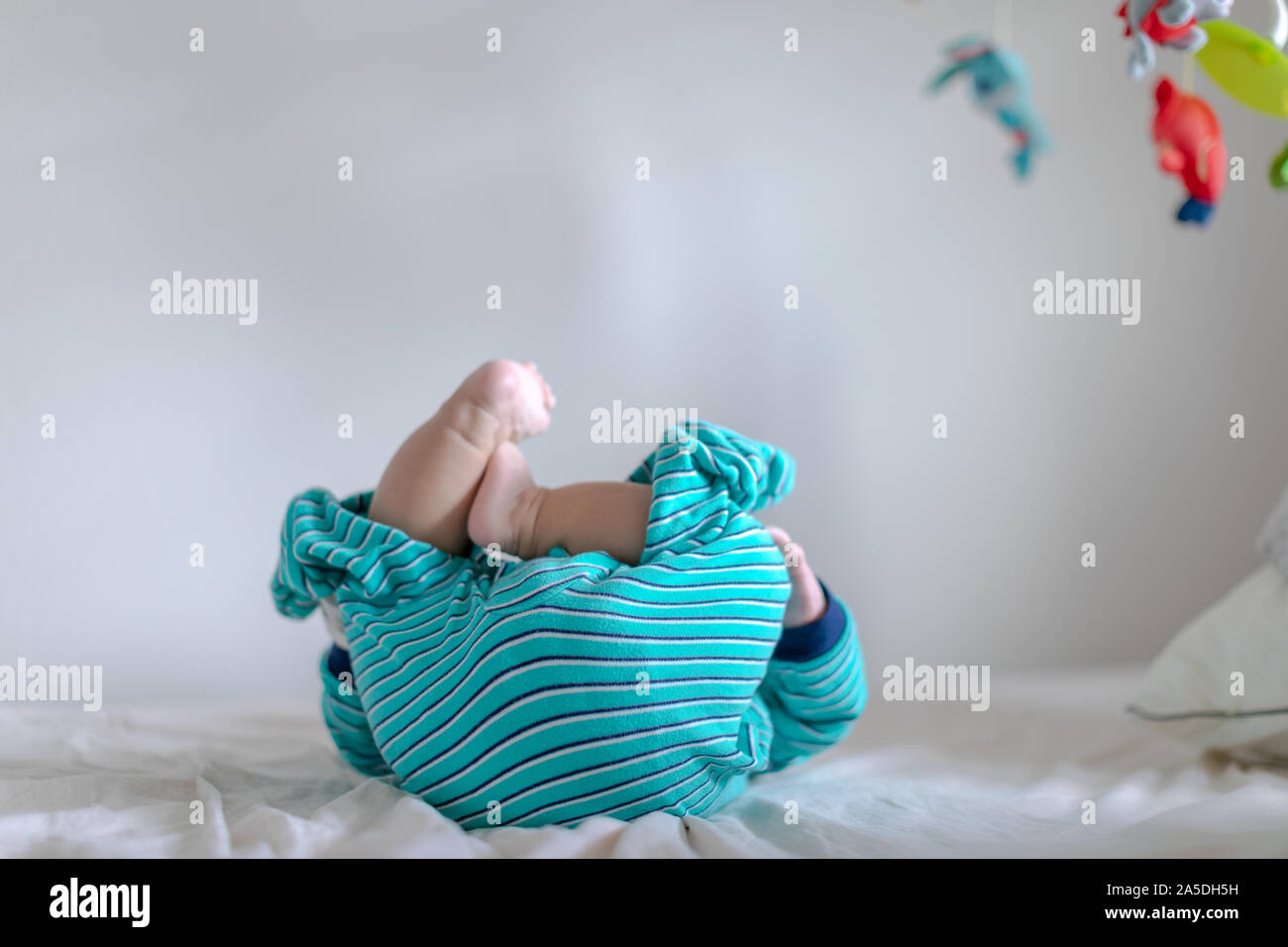 Cute baby boy rolling on bed and playing at home Stock Photo - Alamy