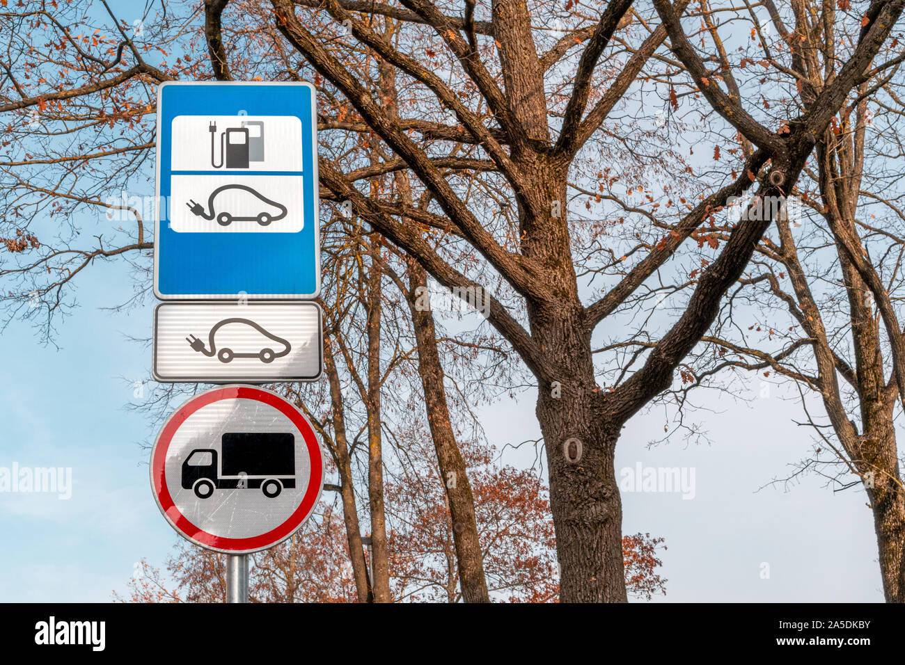 Electric car charging station road sign with trees background Stock ...