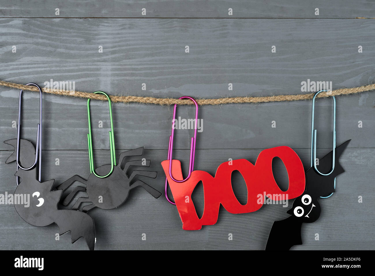 Halloween bats, spider and red "boo" photo booth props hanging on a ...