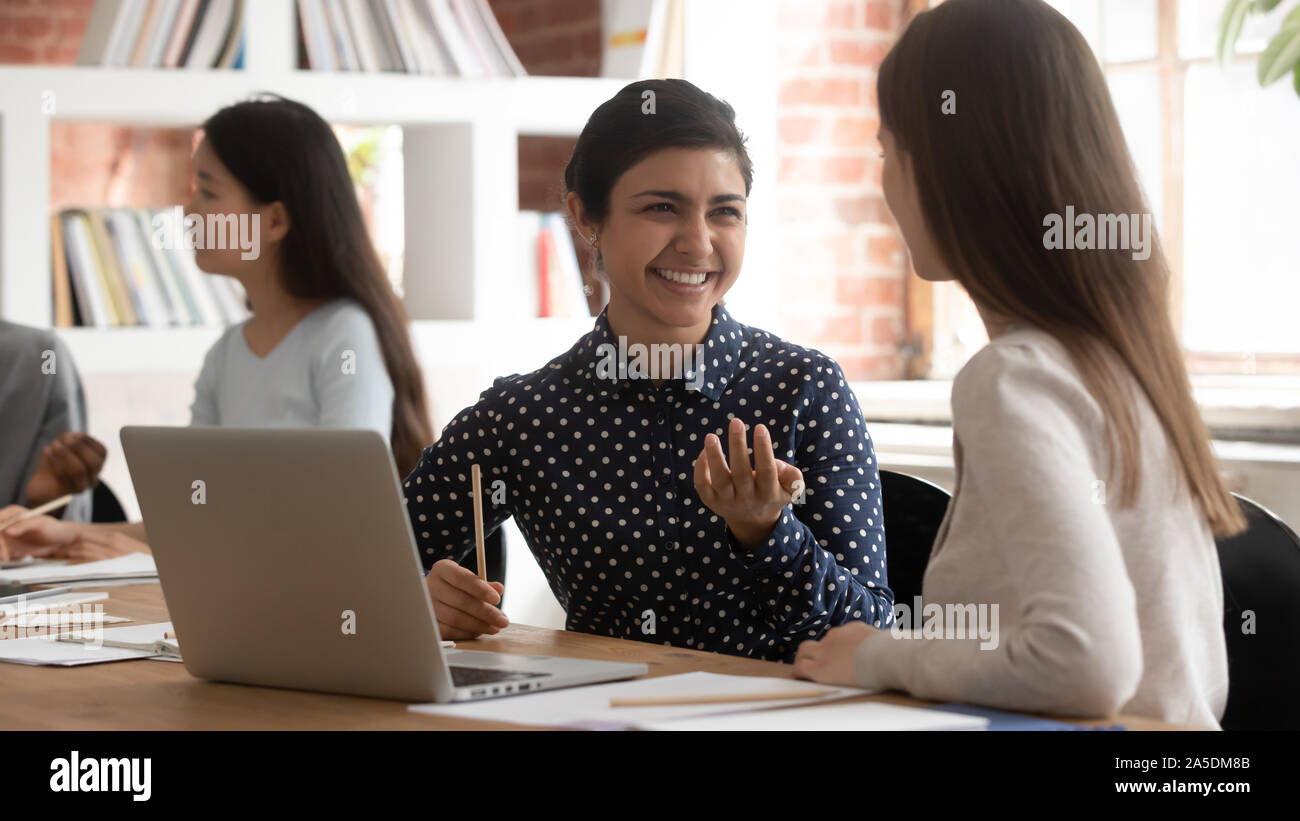 Multiracial students seated inside of modern classroom do shared task ...