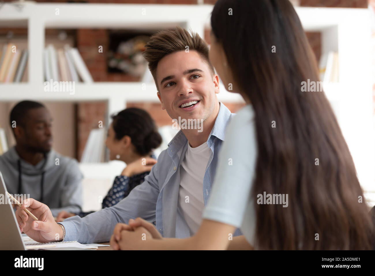 European guy vietnamese girl classmates studying together sitting at ...