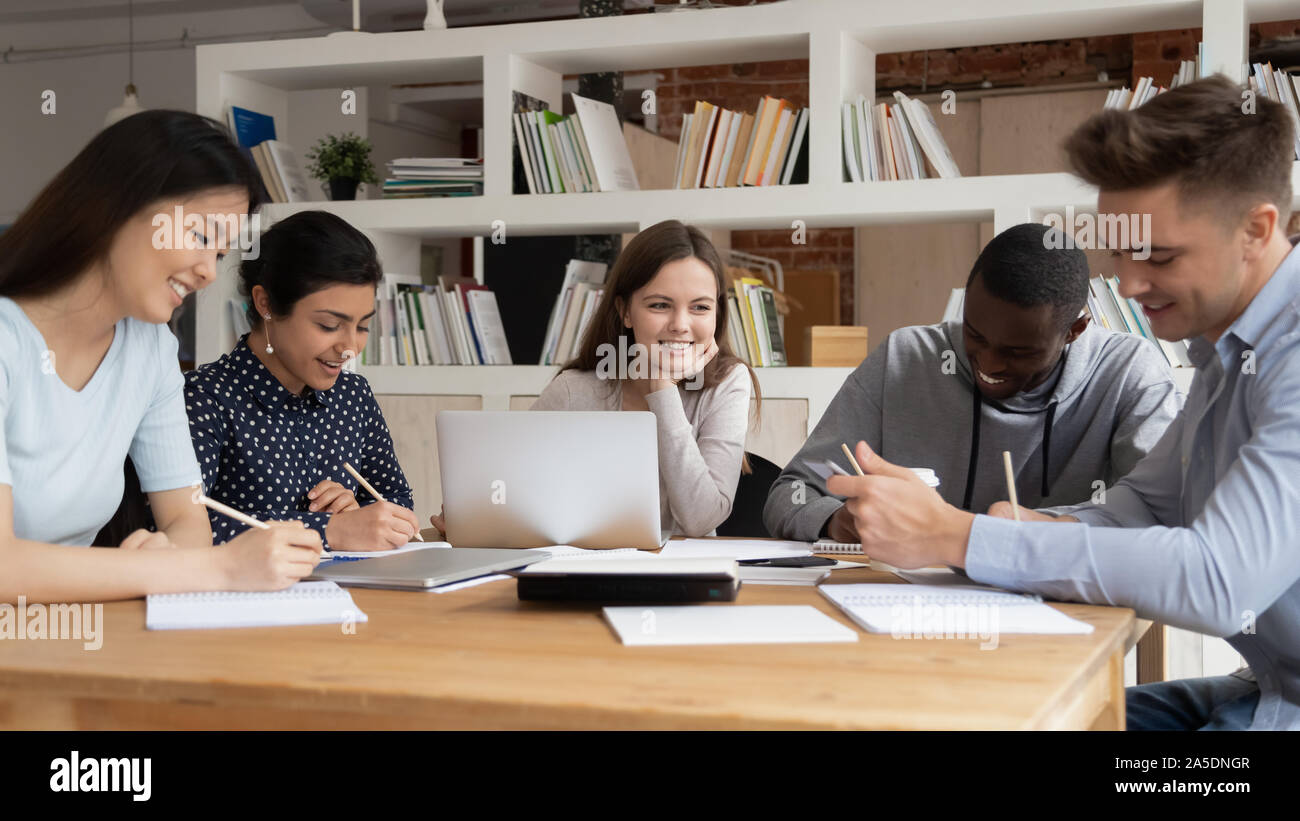Multi-racial students study together seated at library desk Stock Photo ...