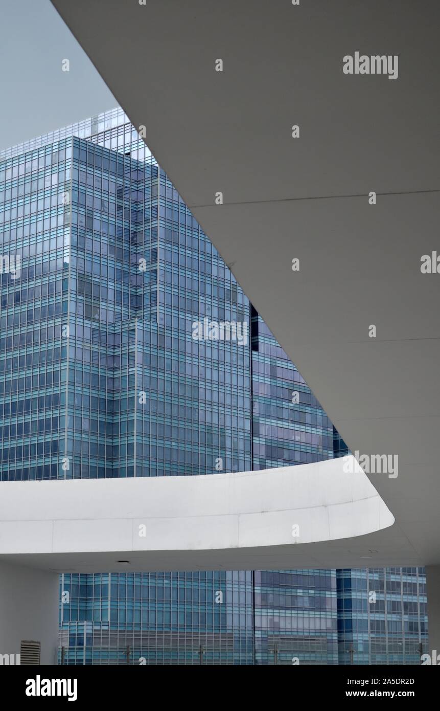 Low angle vertical shot of a white slide covering the high rise glass ...