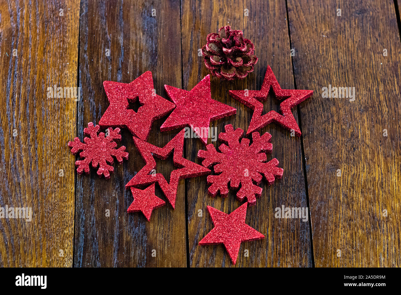 Colorful, glittery and shiny Christmas decorations on wooden board ...