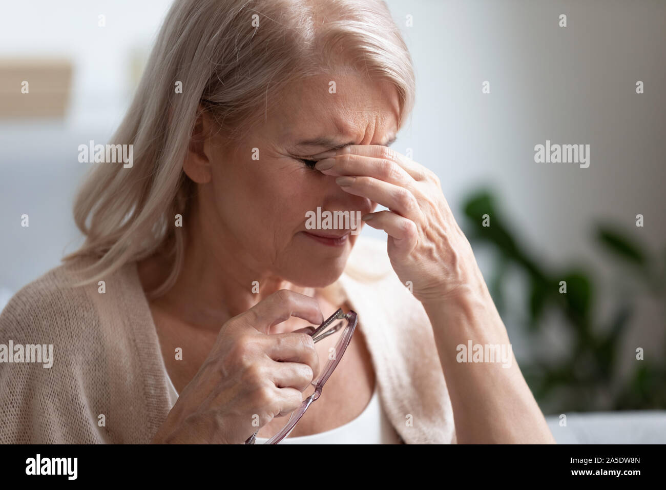 Tired upset middle aged woman taking off glasses rubbing eyes Stock ...