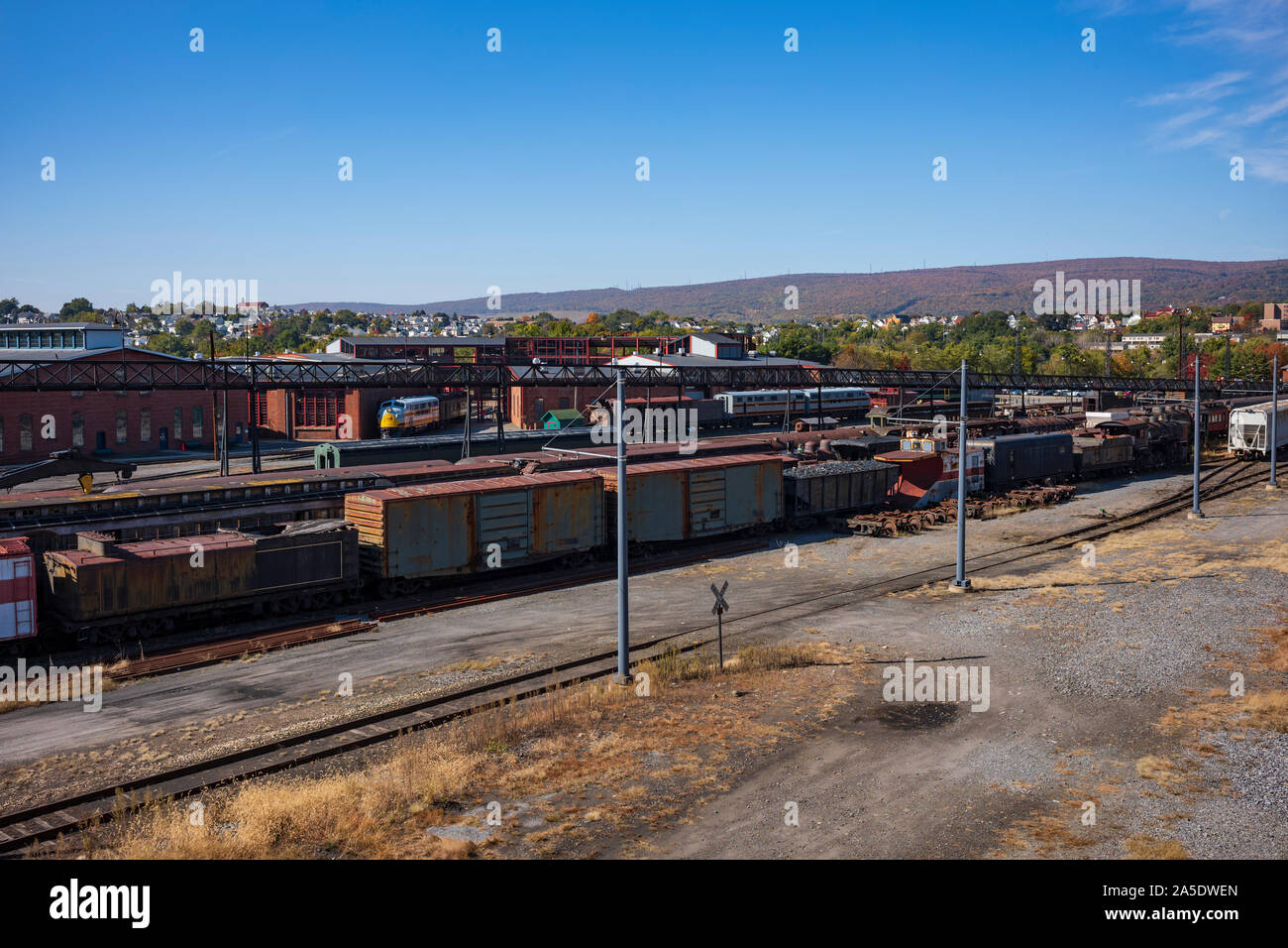 Vintage train cars and locomotives, covered in rust and are in ...