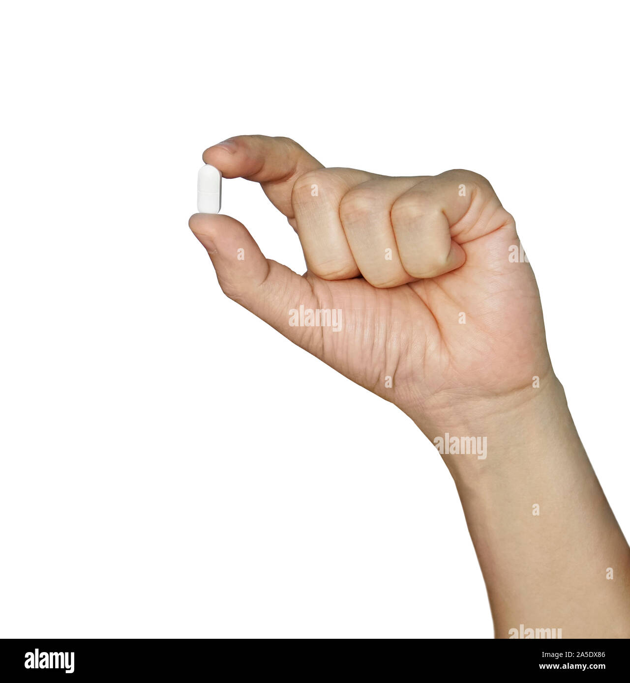 Hand holding a pill between thumb and forefinger isolated on white ...