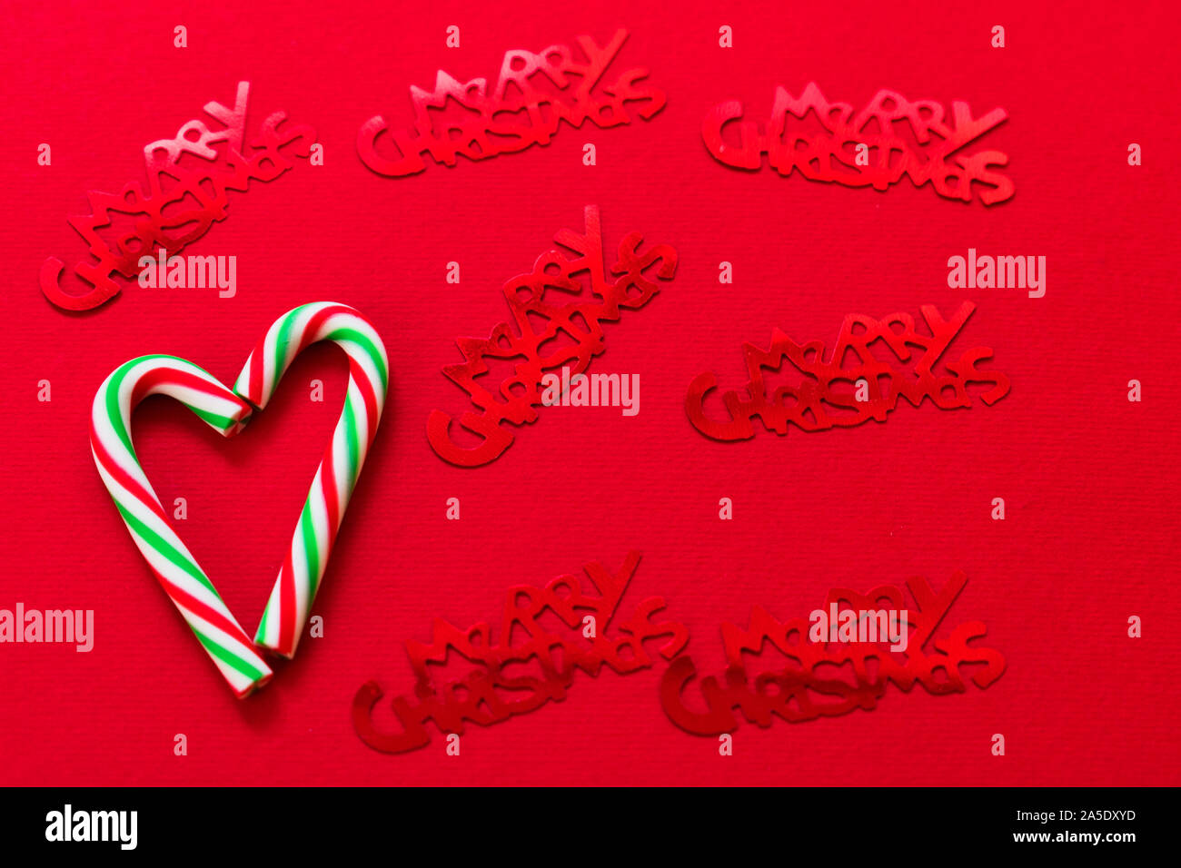 Heart made of Christmas candies and red shiny lettering with Christmas ...