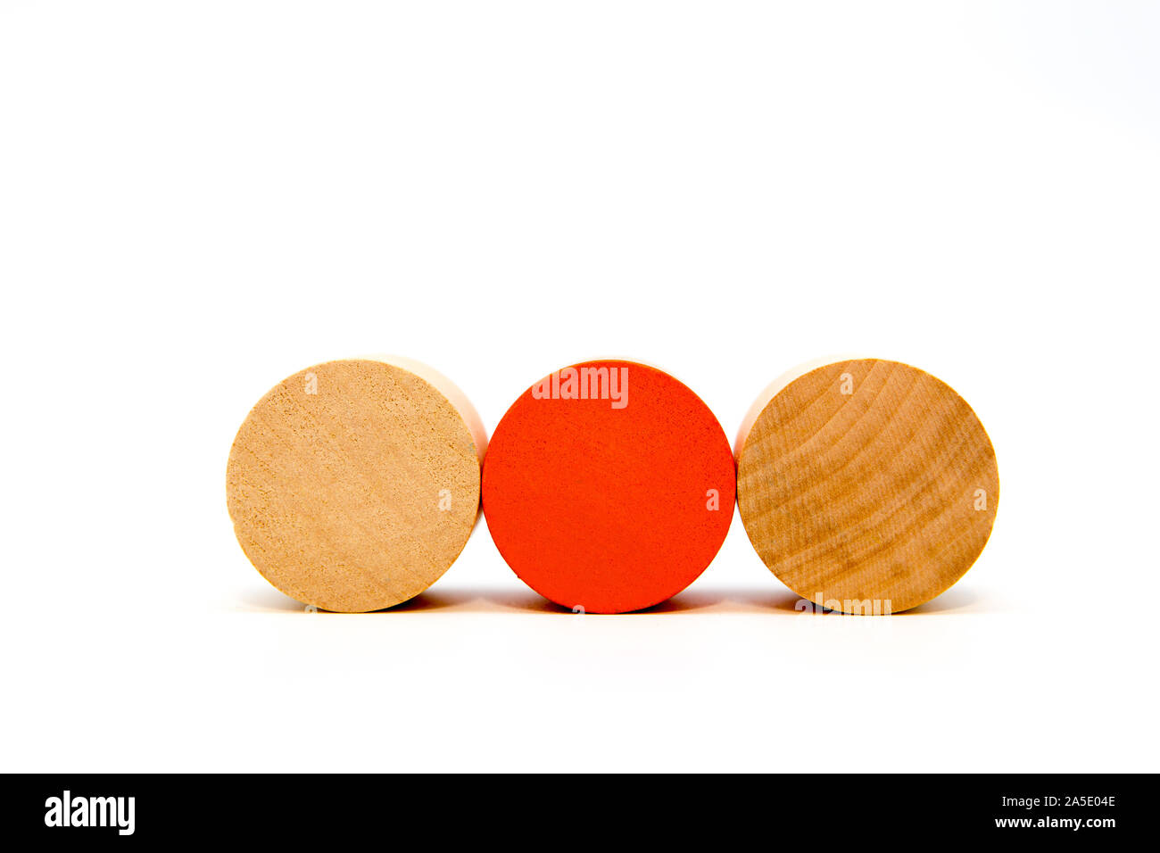 two natural and one red round wooden toy blocks isolated on white ...