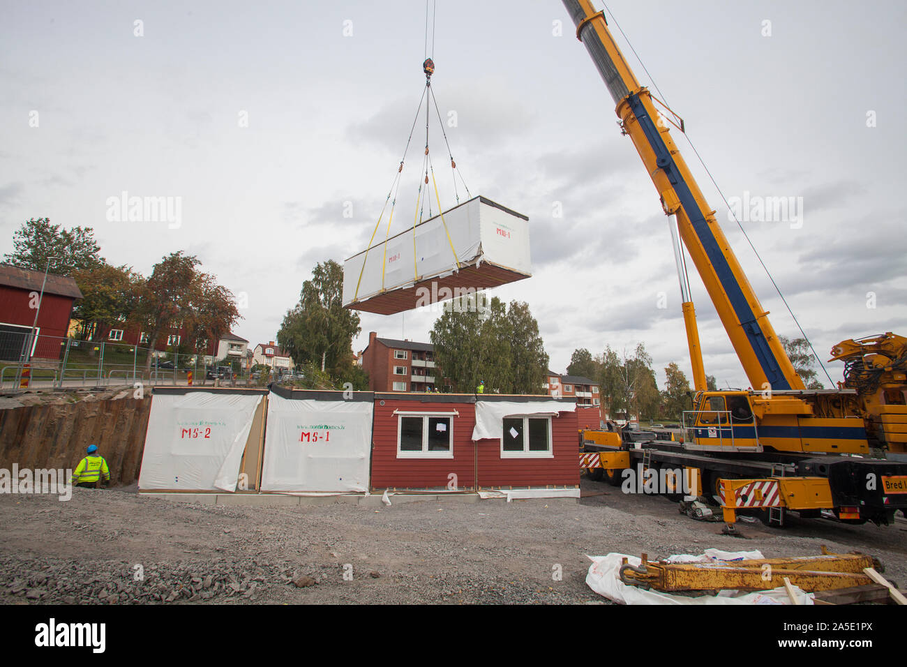 The three-storey apartment building is built of wooden modules that are ...