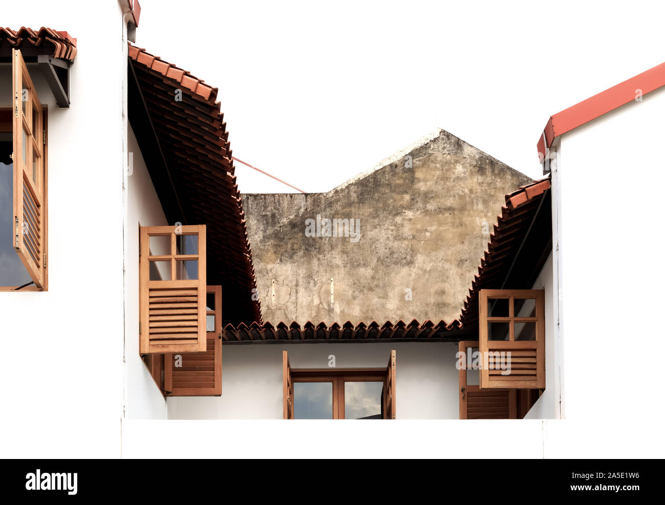 Traditional vintage shop house windows with antique shutters on a white ...