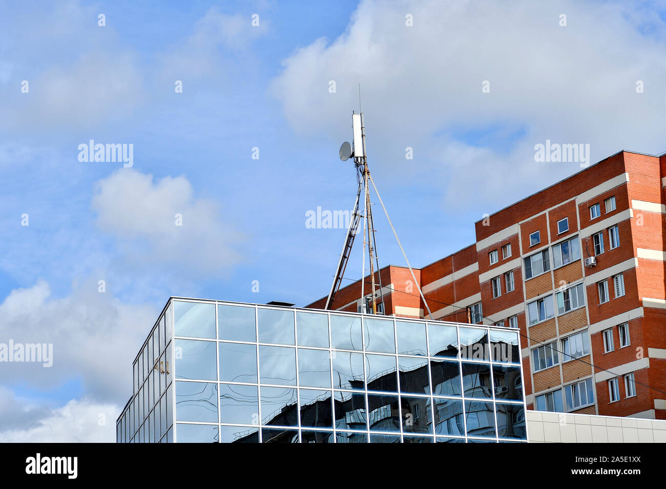 Small antennas on a metal support on the roof of a modern building ...