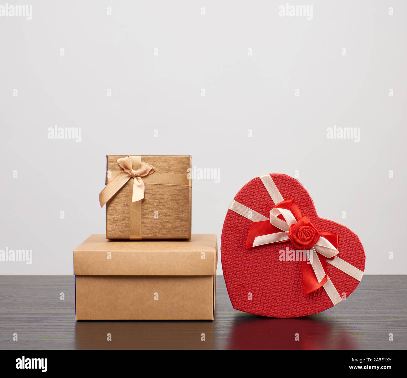 stack of various cardboard boxes for gifts on a black table, white ...