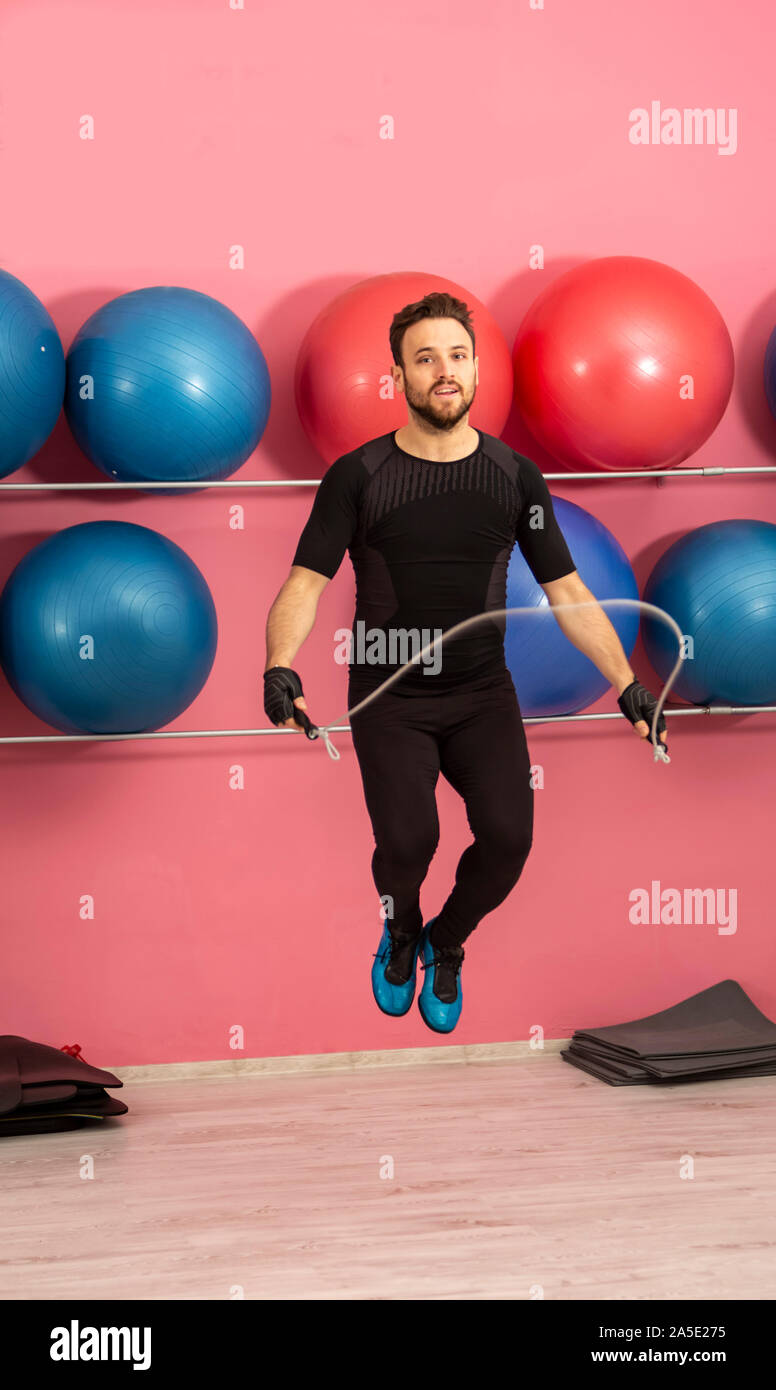 Image of a man jumping the rope in a gym Stock Photo - Alamy