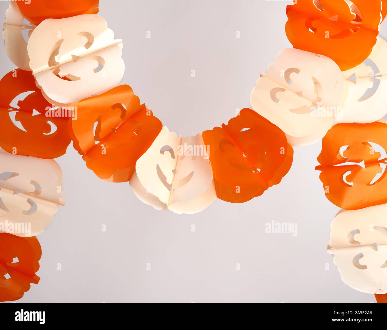 plastic garland on with carved figures of pumpkins, object is isolated ...