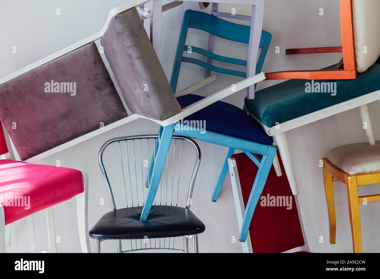 lots of different chairs in the interior of an empty white room Stock ...
