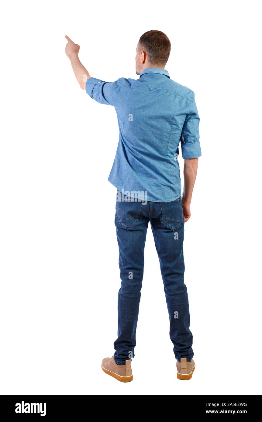 Back view of a man in jeans points his hand upwards. Rear view people ...