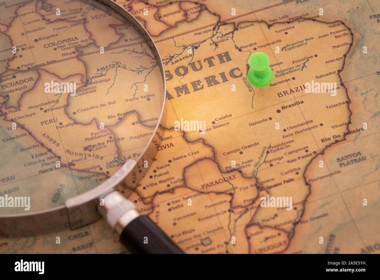 Retro map of South America with a magnifying glass and a green point ...