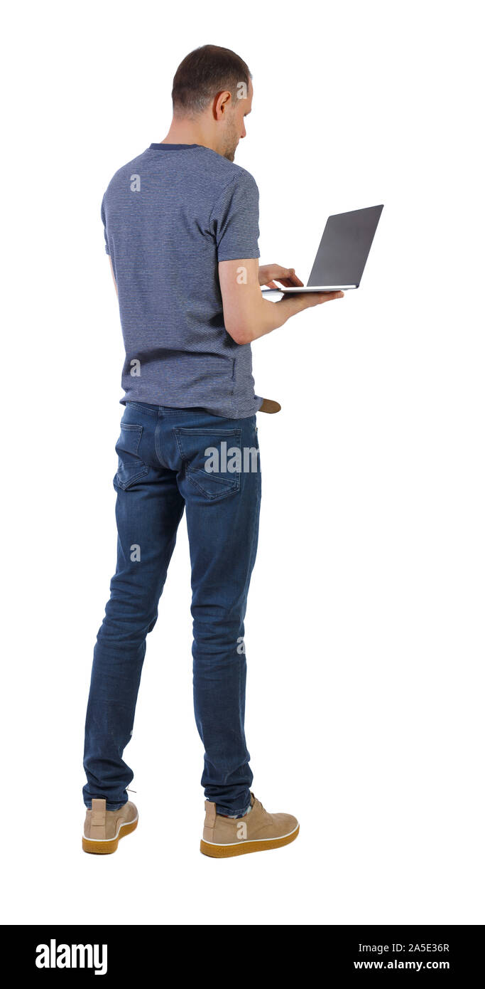 Back view of a man who is standing with a laptop. Rear view people ...